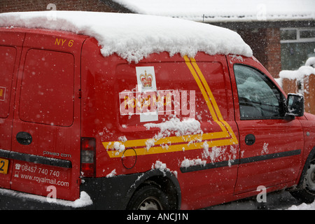 A Royal Mail post delivery van parked in the street outside a semi ...