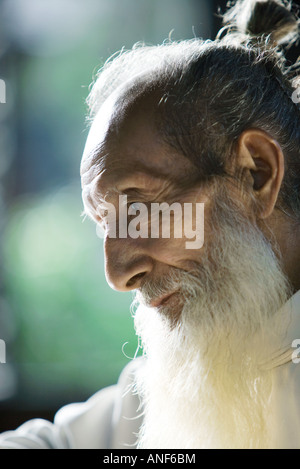 Profile portrait of a man with a long beard and a short haircut in ...