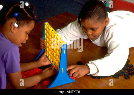 Kids playing Connect Four vertical checker game. After School Study ...