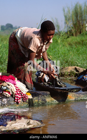 Portrait of an African woman washing clothes by hand in buckets. Accra ...