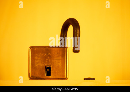 Padlock on Plain Yellow Background with key Stock Photo - Alamy