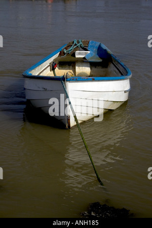 A small fishing boat is moored in front of a hotel on the stunning ...