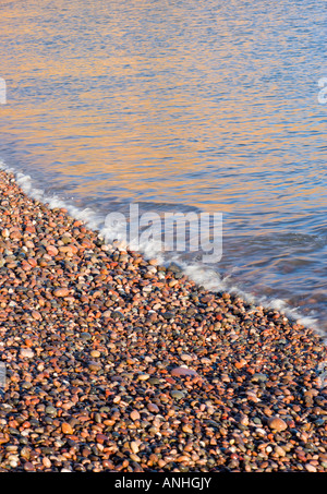 Pebbles on beach in the surf at low tide, Germany Stock Photo - Alamy