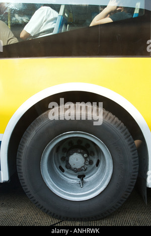 Part of a yellow city bus with passengers Stock Photo - Alamy
