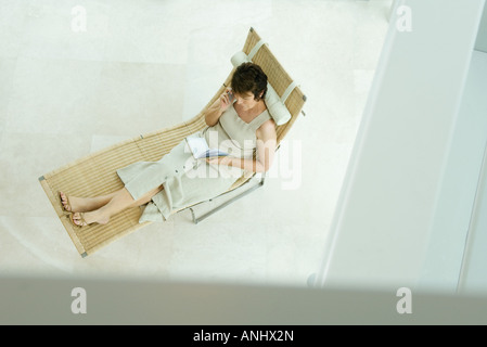 Overhead view of woman talking with diary using smart phone while ...