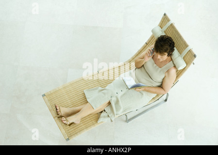 Overhead view of woman talking with diary using smart phone while ...
