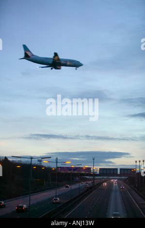 A plane flying over the M1 motorway in Leicestershire UK to land at ...