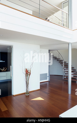 View of an eclectic hallway with a winding staircase Stock Photo - Alamy