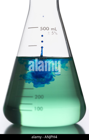 Liquid being poured into a conical flask with a test tube Stock Photo ...