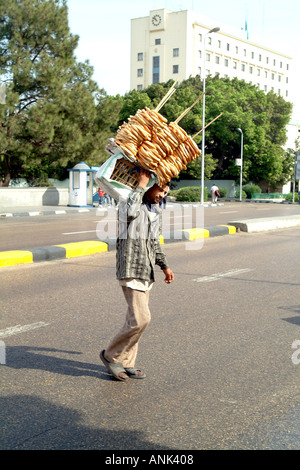 Egyptian man carrying bread in Cairo Stock Photo - Alamy