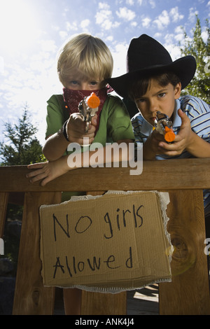 Two boys playing cops and robbers Stock Photo - Alamy