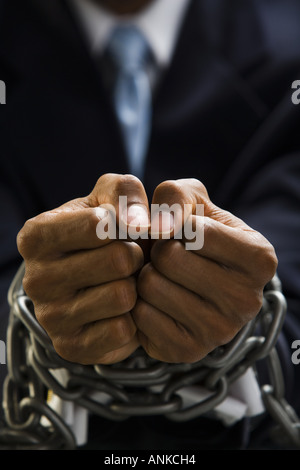 Man with chains around wrists Stock Photo - Alamy