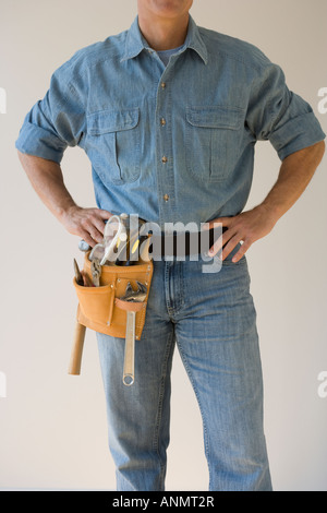 Repairman wearing tool belt Stock Photo - Alamy