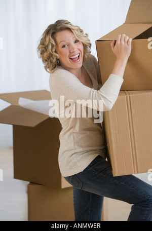 clumsy young woman dropping moving boxes and tripping. on white ...