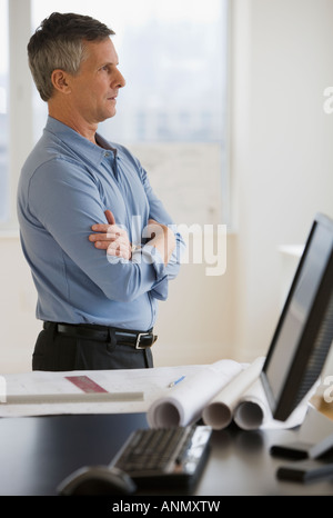 Serious businessman with crossed arms Stock Photo - Alamy