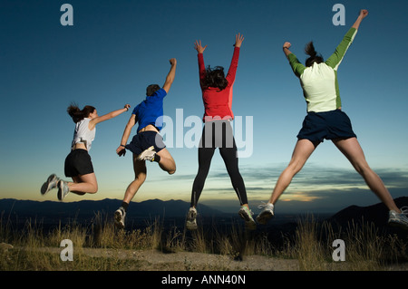 Rear view of man jumping on railway tracks amidst trees Stock Photo - Alamy