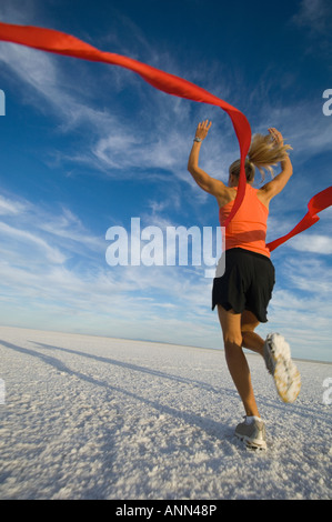 Woman running across finish line, Utah, United States Stock Photo - Alamy