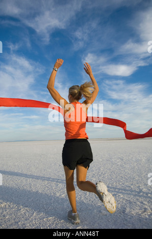 Woman running across finish line, Utah, United States Stock Photo - Alamy