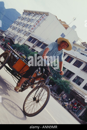 Street scene: bike, man with cart near laundry Stock Photo - Alamy