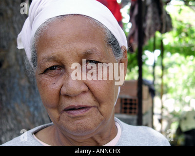 Portrait of a Turkish senior muslim woman with black background. She ...