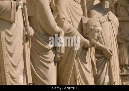 Statue of Bishop of St Denis on west face of Notre-Dame Cathedral Stock ...