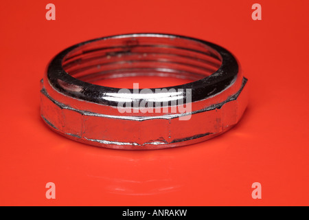 Metal nut used to connect a drain Stock Photo - Alamy