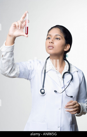 Asian female medical professional examining anatomical brain model ...