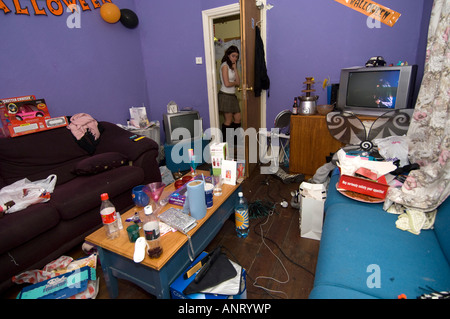 An untidy living room lounge in a student house the morning after a ...