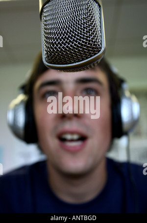 Boy using microphone in a studio Stock Photo - Alamy