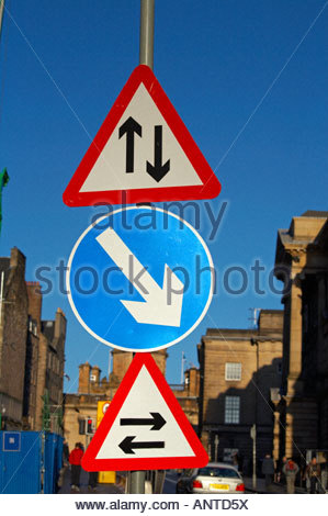 left and right two traffic circle shaped U Turn sign with post on white ...