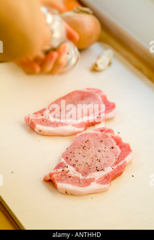 Raw pork steaks with seasoning on wooden board. Gray slate background ...
