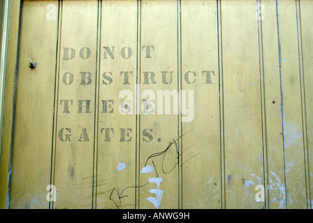Stencilled notice on garage doors Do Not Obstruct These Gates Stock ...