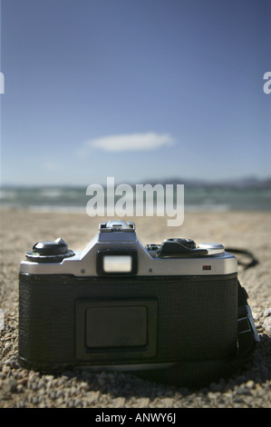 Photographer Lying on Sandy Beach Capturing Ocean Waves With Camera ...