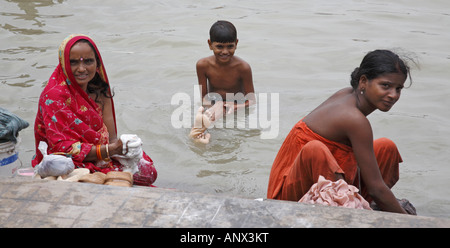 Young Indian woman washing clothes outside her home in a rural indian ...