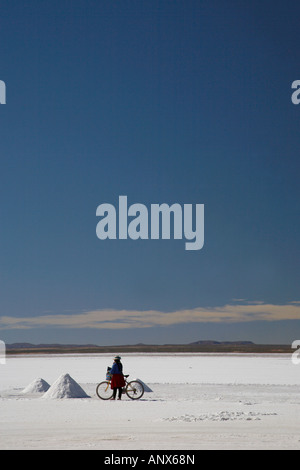 Bolivian woman with bike, salt flats, Bolivia Stock Photo - Alamy