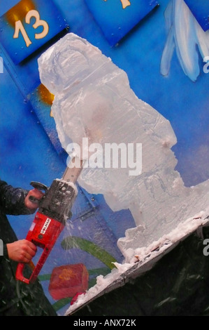 artist modelizing an ice block with a chain saw Stock Photo - Alamy