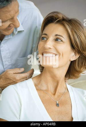 Mature woman putting in contact lenses on brown background Stock Photo ...