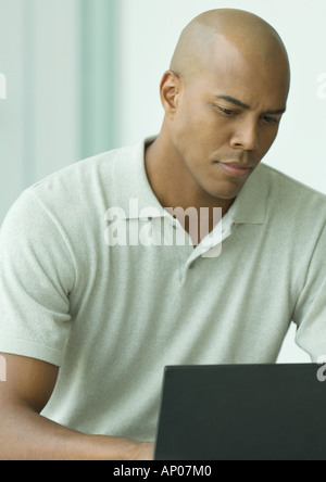 a black man works at a laptop close-up of his face. video conferences ...