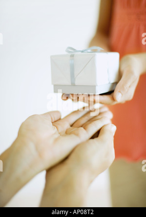 Gift offering handing present hands wrapped box Stock Photo - Alamy