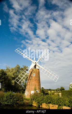 Hunsett Mill windmill on Norfolk Broads in English cottage garden a ...