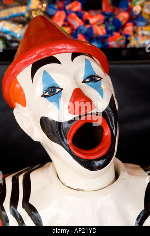 Laughing white face of sideshow clown with red nose, mouth and hat ...