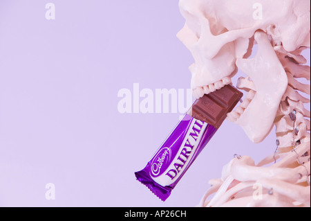 A human skeleton eating a bar of chocolate Stock Photo - Alamy