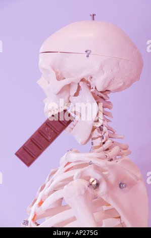 A human skeleton eating a bar of chocolate Stock Photo: 15654471 - Alamy