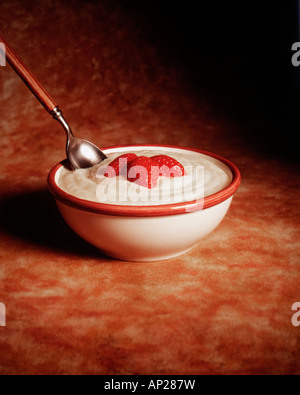 healthy breakfast with warm porridge and strawberry in an enamel cup ...