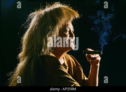 Woman with wig smoking a cigar, Batanes Islands, Philippines Stock ...