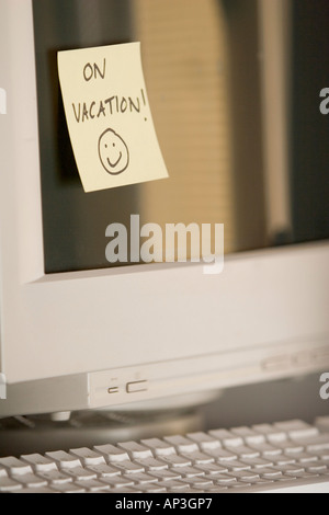 On vacation sticker on computer screen workstation Stock Photo - Alamy