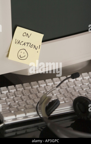 On vacation sticker on computer screen workstation Stock Photo - Alamy