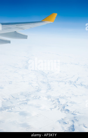 Airplane flying over a snowy landscape in Rovaniemi, Finland on a ...