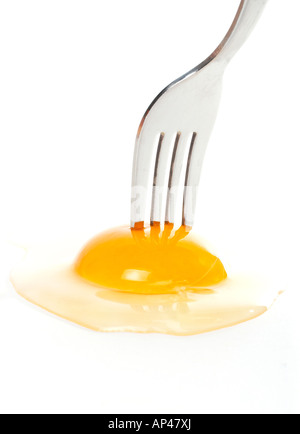 Egg yolk with fork pricking Stock Photo - Alamy