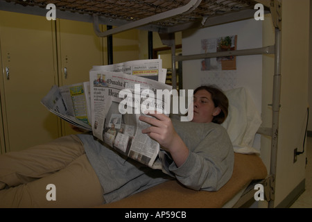 Female inmate reading on her bed in her cell Nebraska Correctional ...